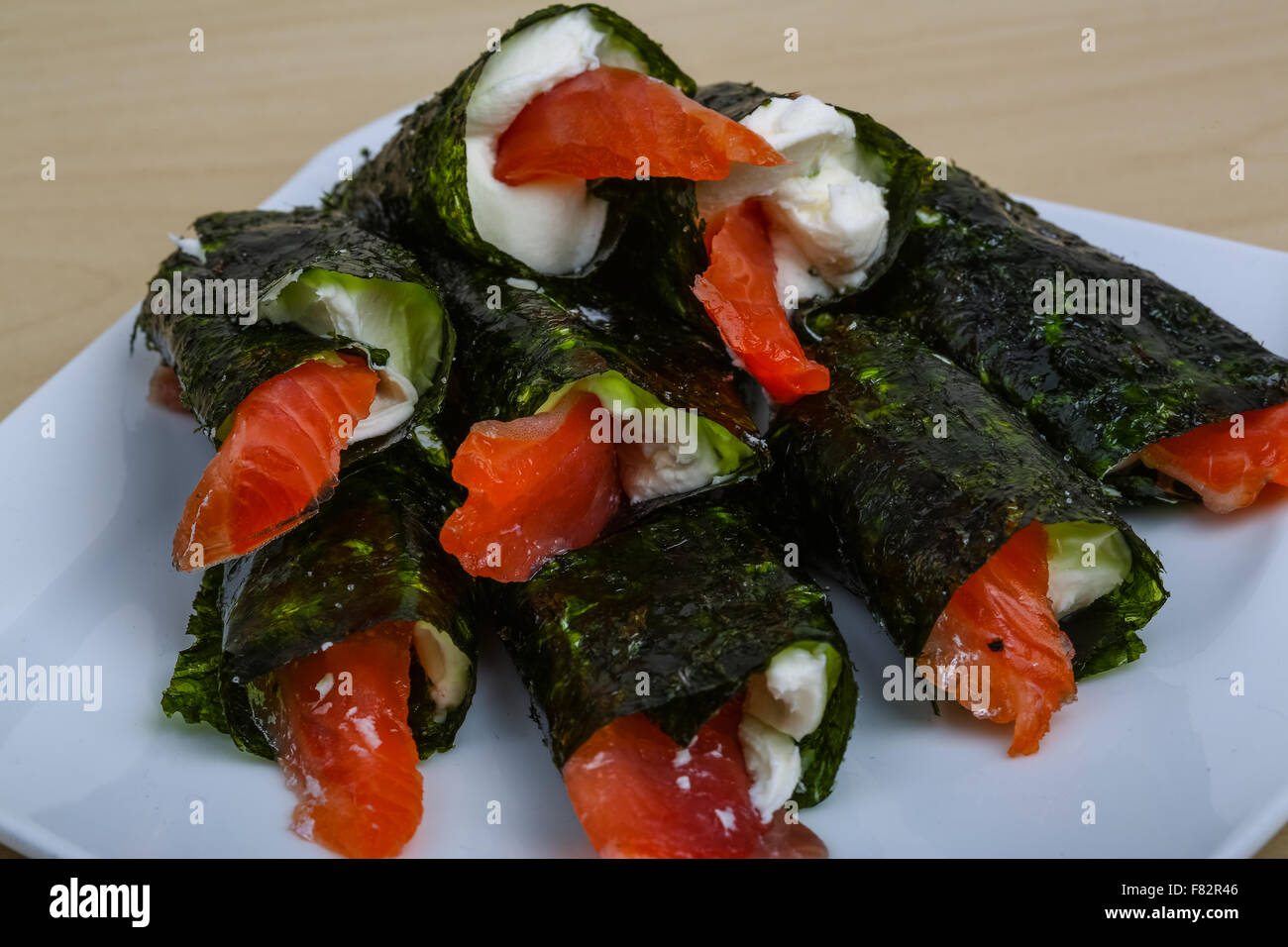 Roll with salmon, nori and soft cheese Stock Photo - Alamy