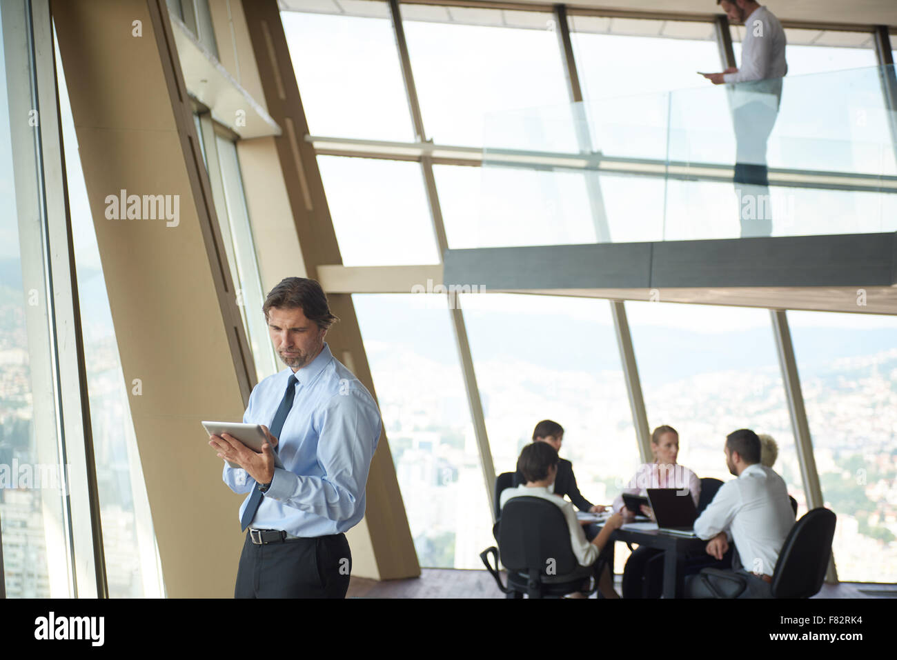 handosme business man working on tablet computer at modern bright ...