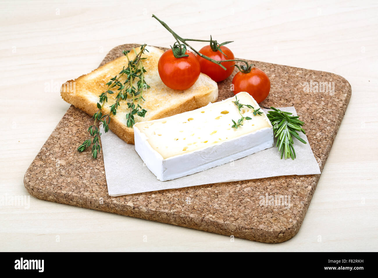 Soft brie cheese with rosemary, thyme and toast bread Stock Photo - Alamy