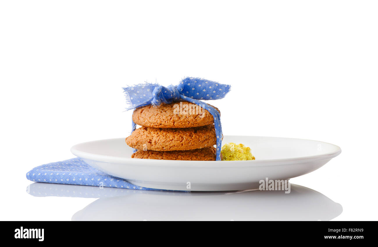 Stack of three homemade oatmeal cookies tied with blue ribbon in small ...