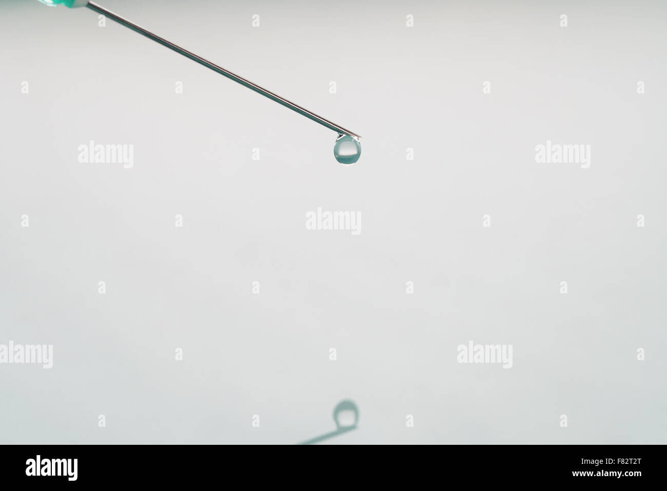 liquid drop on the tip of syringe Stock Photo - Alamy