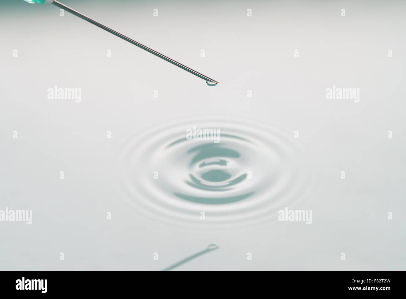 liquid drop on the tip of syringe Stock Photo - Alamy
