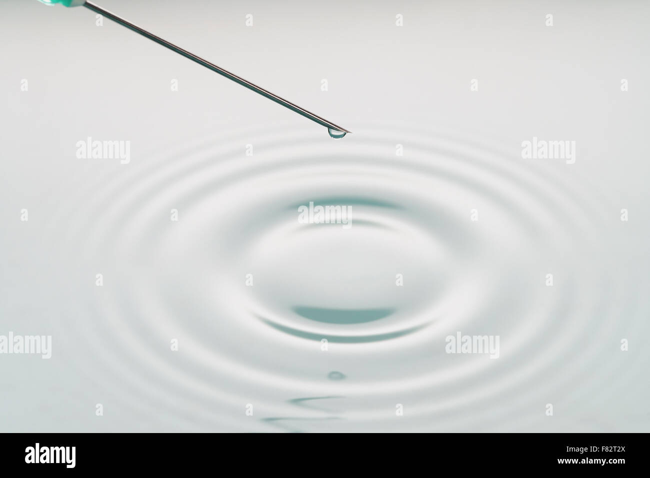 liquid drop on the tip of syringe Stock Photo - Alamy
