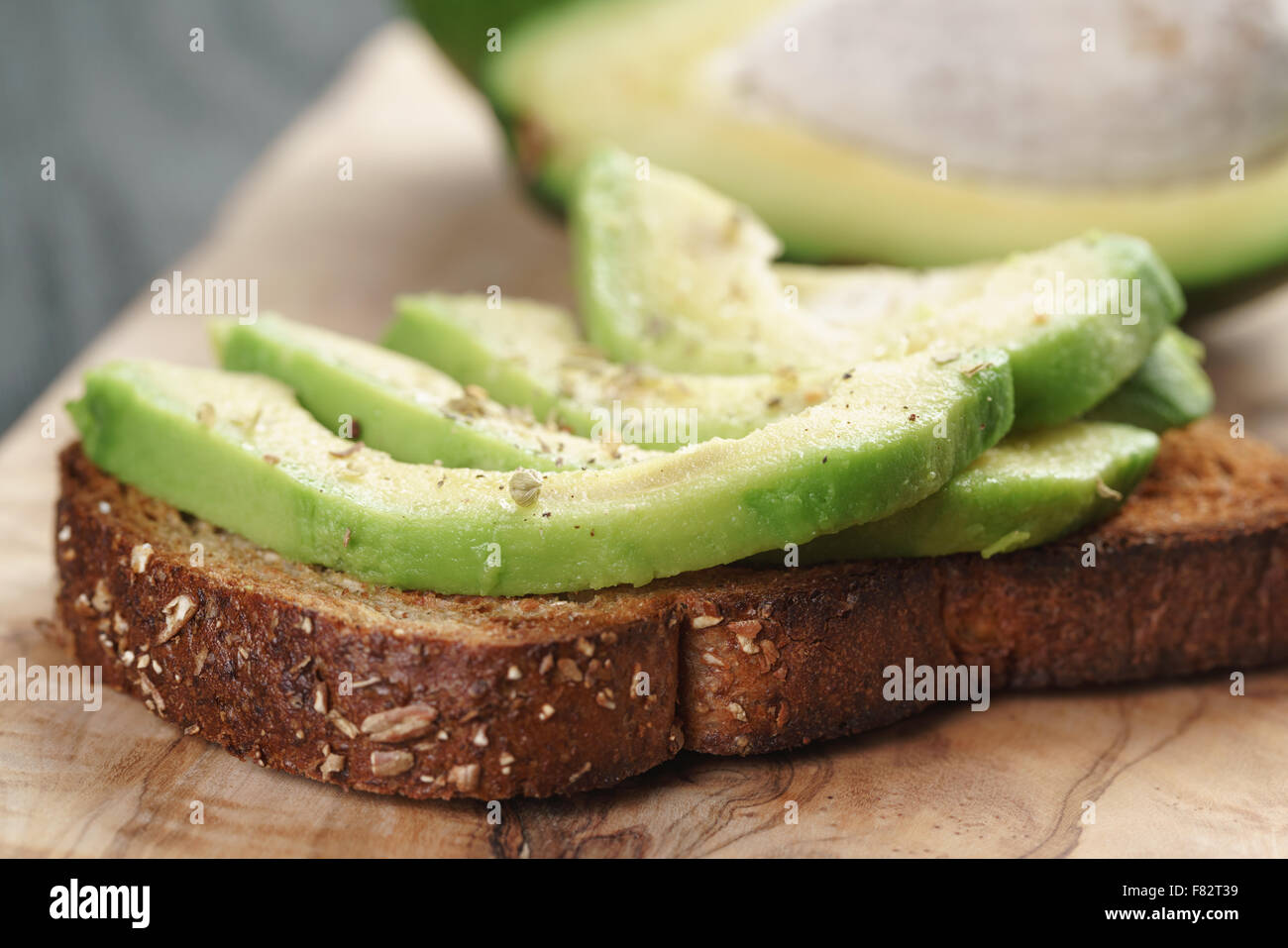 toasted rye bread with sliced avocado and herbs Stock Photo - Alamy