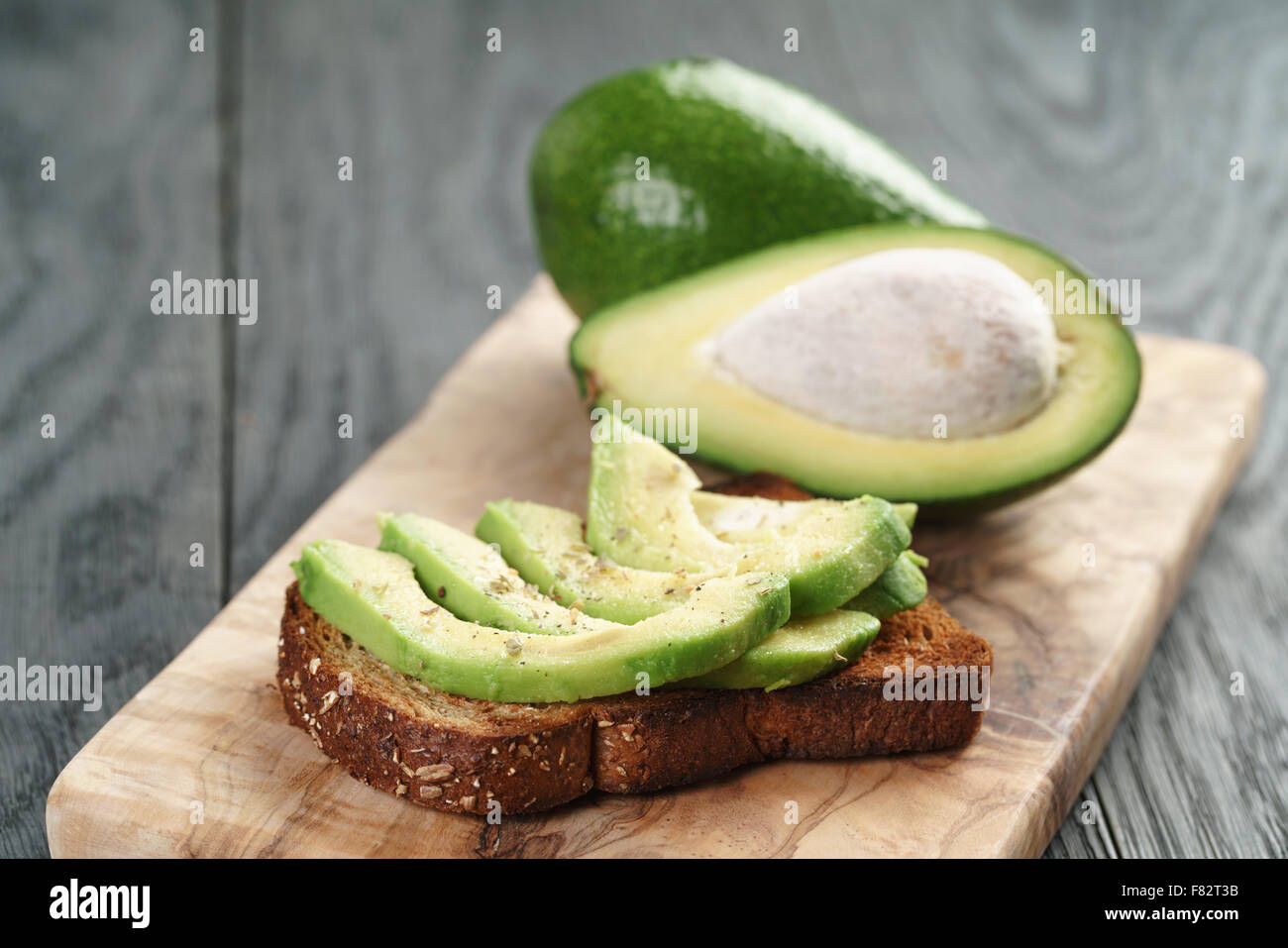 rye toast with sliced avocado and herbs Stock Photo - Alamy