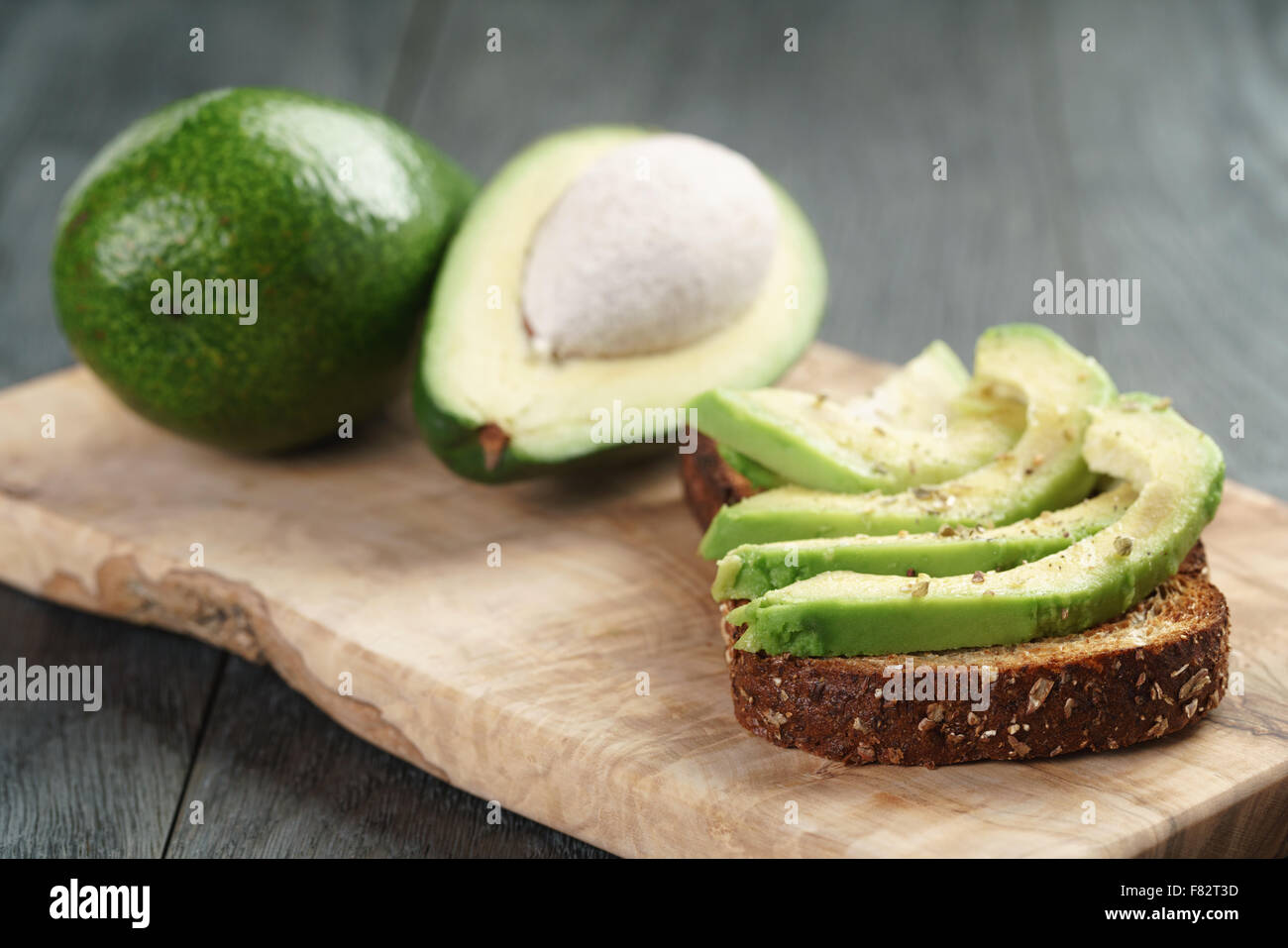 rye toast with sliced avocado and herbs Stock Photo - Alamy