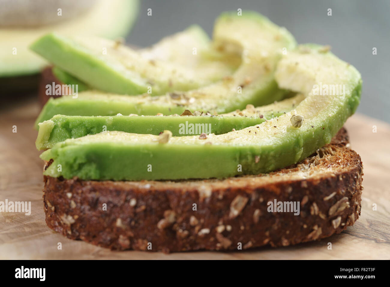 toasted rye bread with sliced avocado and herbs Stock Photo - Alamy