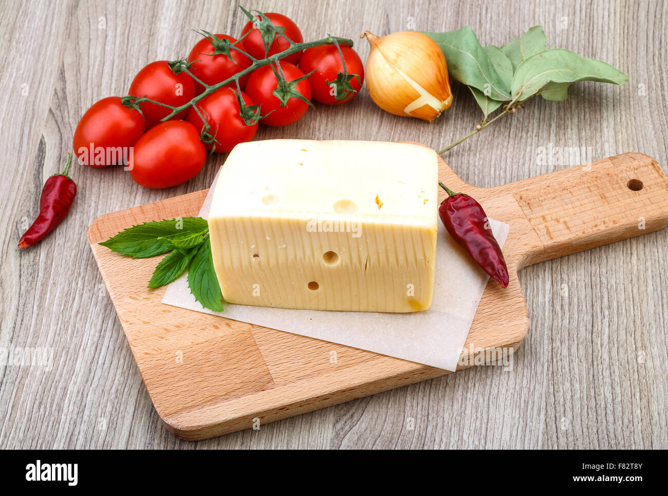 Yellow cheese brick with mint leaves on the wood background Stock Photo ...