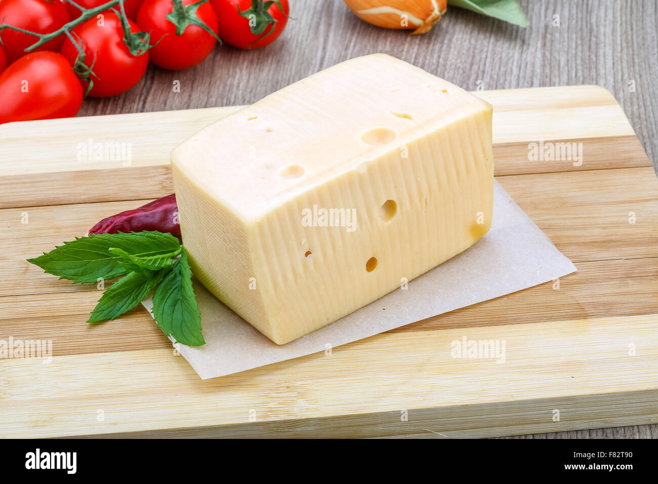 Yellow cheese brick with mint leaves on the wood background Stock Photo ...