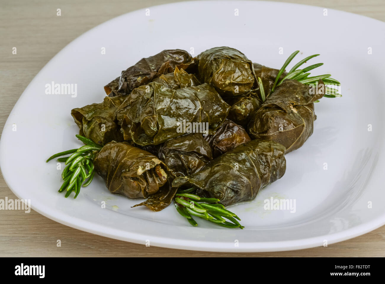 Greek dolma in grape leaves with meat served rosemary Stock Photo - Alamy