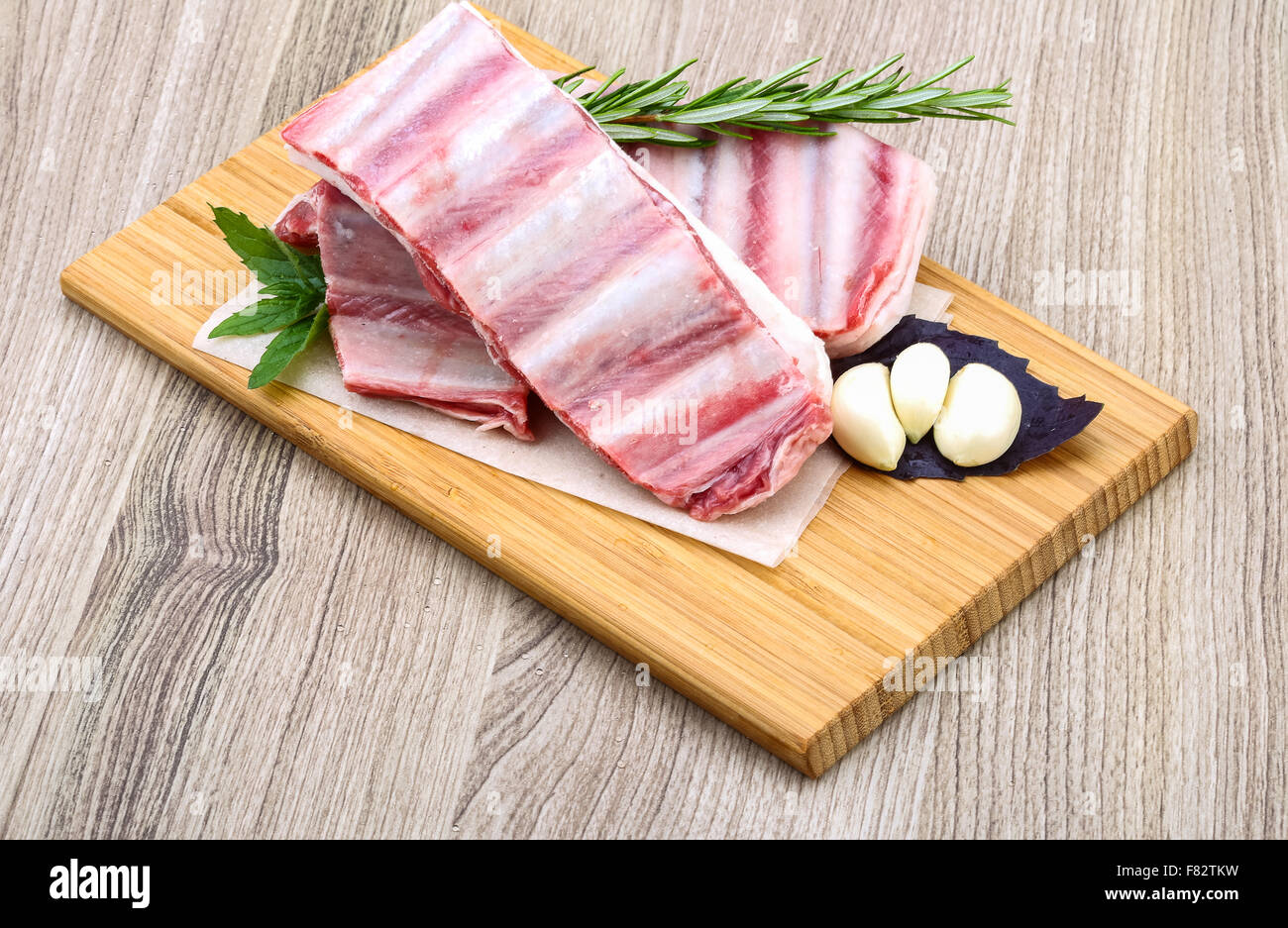 Fresh cold Raw lamb ribs with garlik and pepper - ready for cooking ...