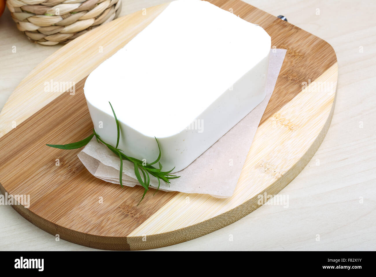 Feta cheese slice on the board with terragon Stock Photo - Alamy