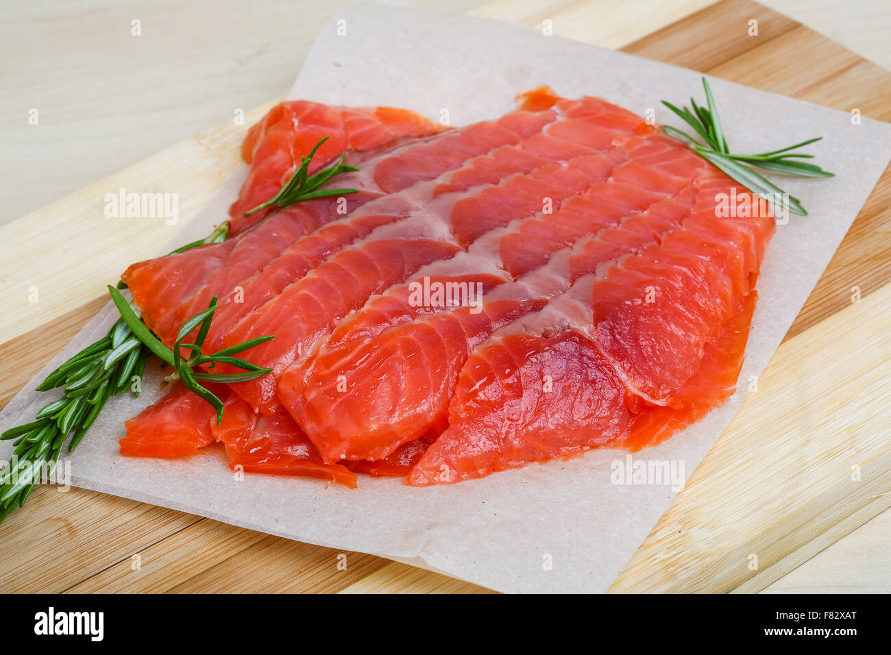 Sliced sashimi with rosenary leaves on the wood background Stock Photo ...