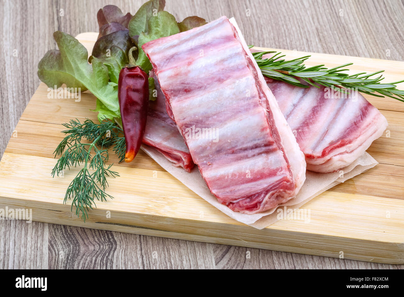 Fresh cold Raw lamb ribs with garlik and pepper - ready for cooking ...