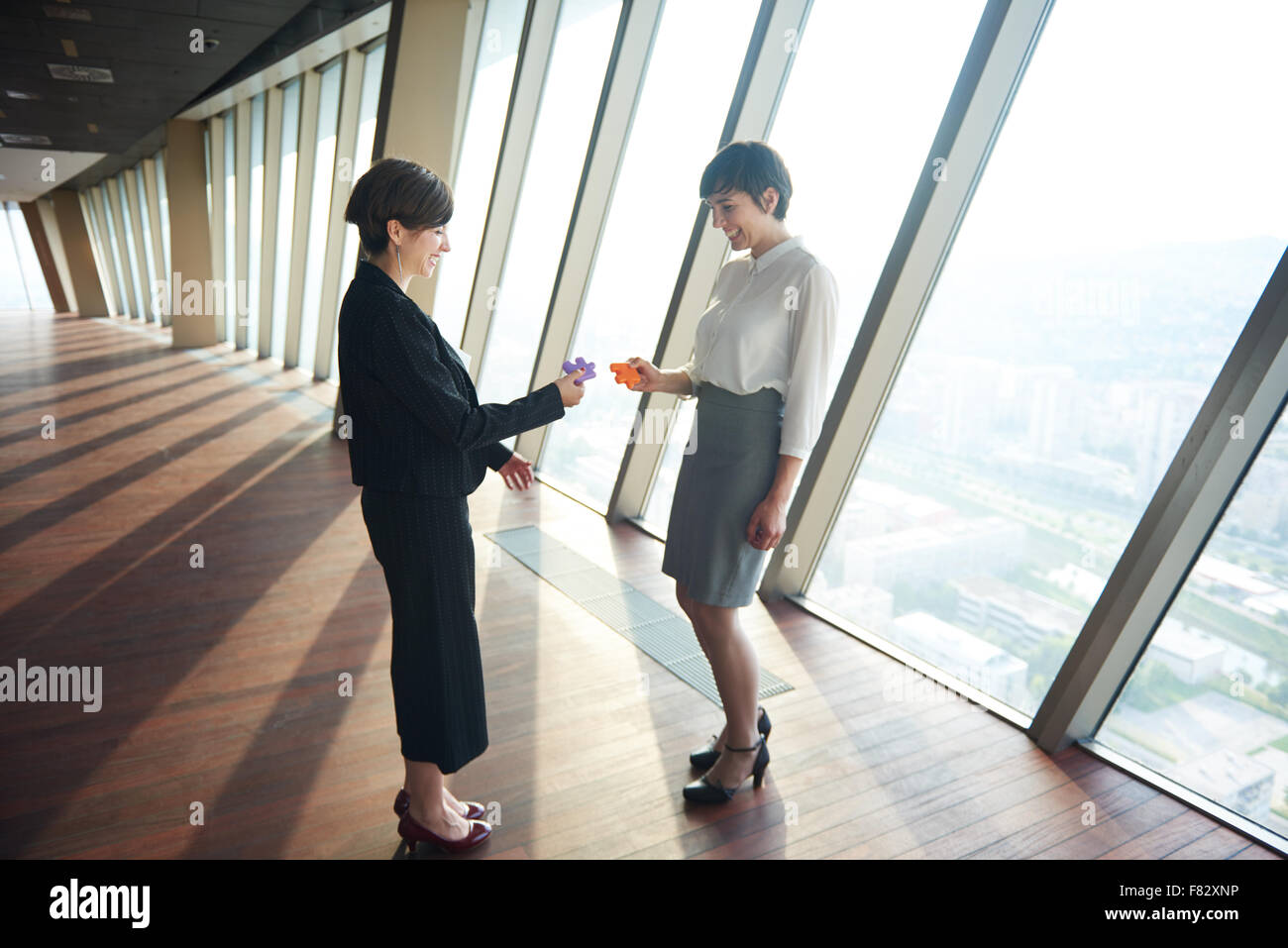 business people group assembling jigsaw puzzle and represent team ...