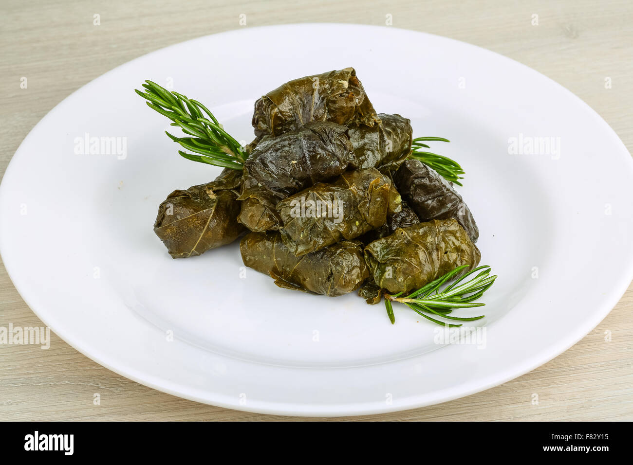Greek dolma in grape leaves with meat served rosemary Stock Photo - Alamy