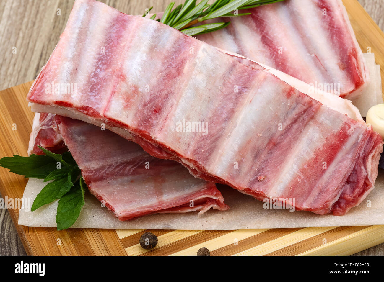 Fresh cold Raw lamb ribs with garlik and pepper - ready for cooking ...