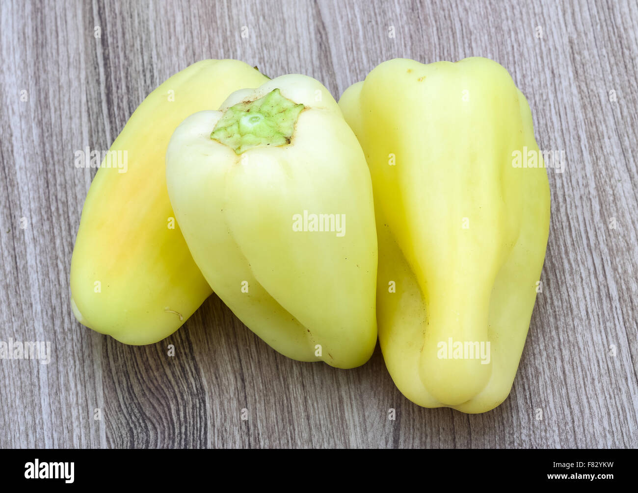 Fresh Yellow peppers on the wood background Stock Photo - Alamy