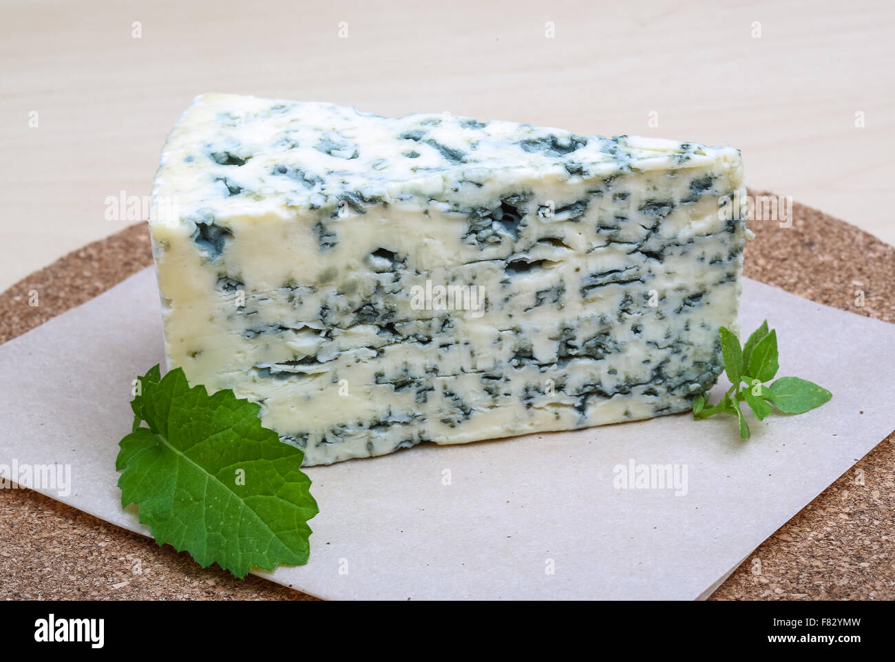 Dor Blue cheese with basil on the wood background Stock Photo - Alamy