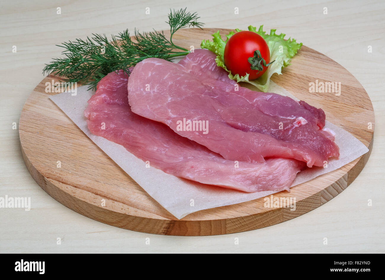 Raw pork schnitzel with dill - ready for cooking Stock Photo - Alamy