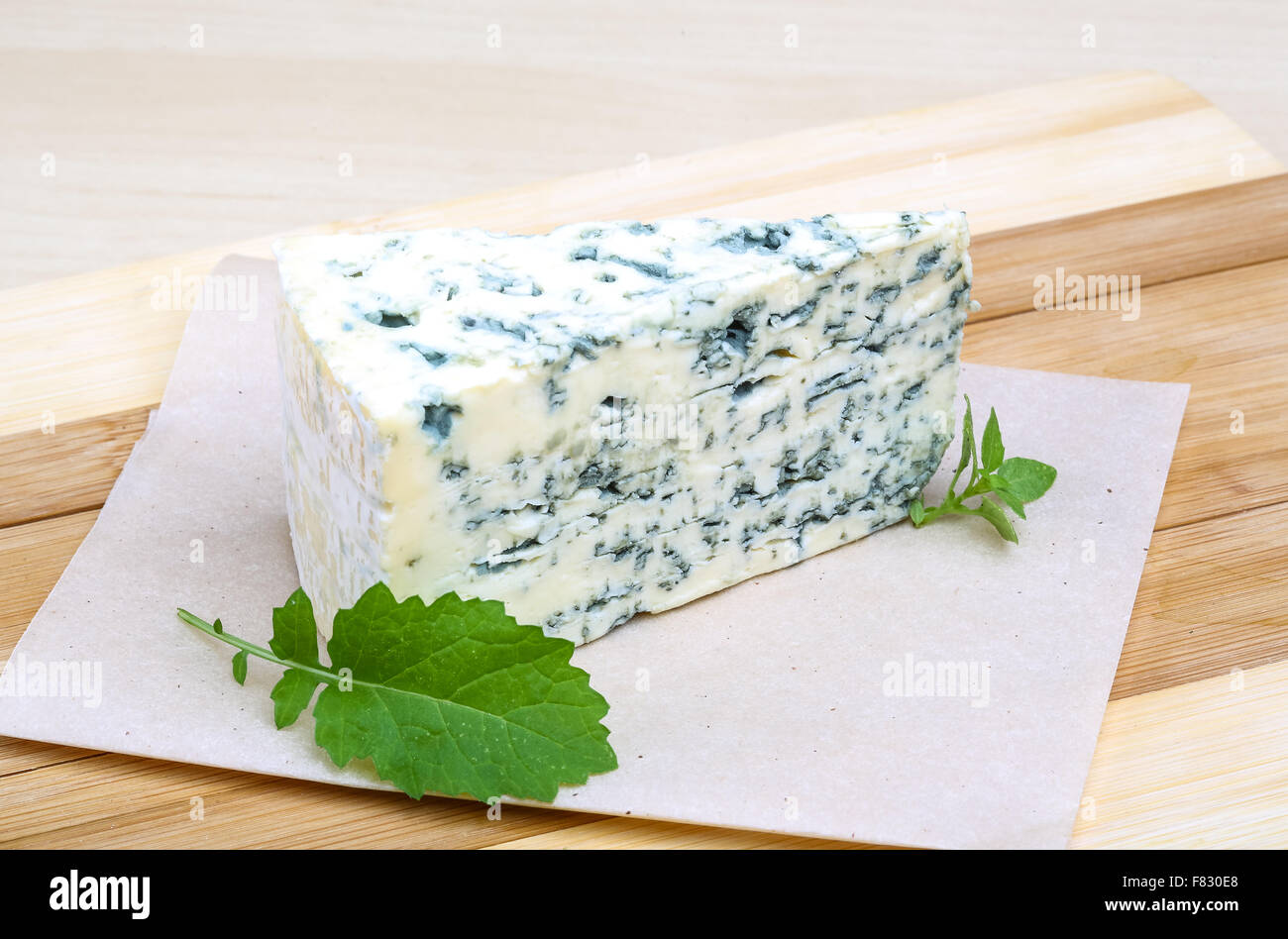Dor Blue cheese with basil on the wood background Stock Photo - Alamy