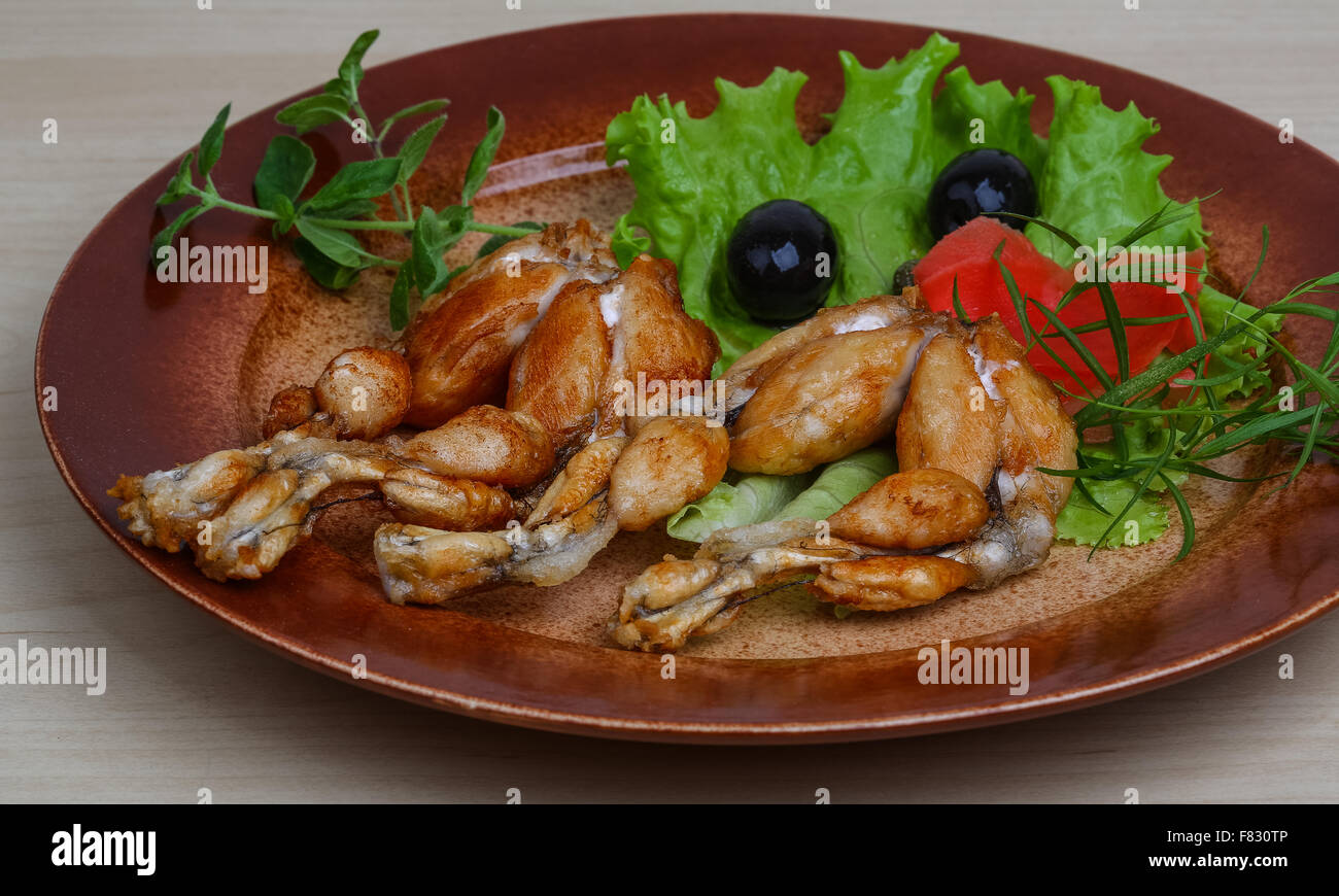Roasted Frog legs with herbs and spices Stock Photo - Alamy