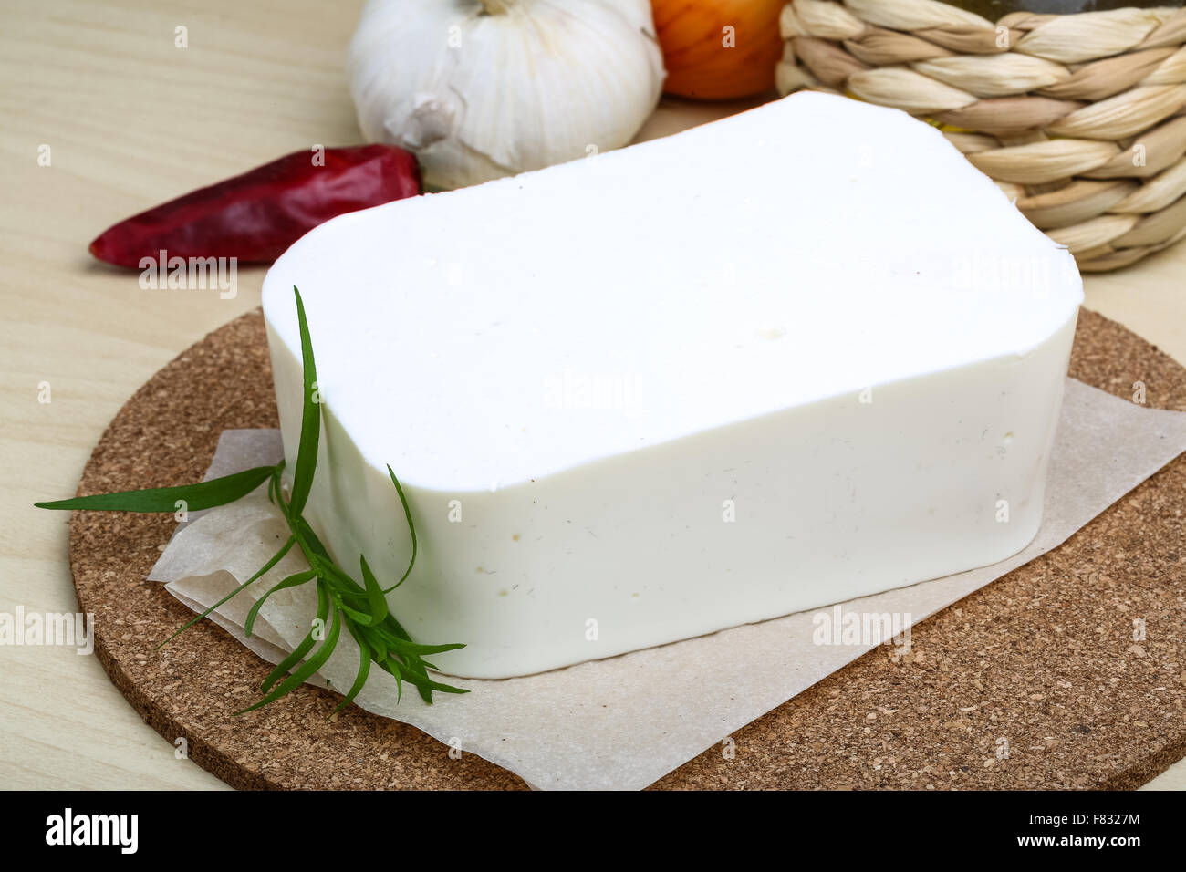 Feta cheese slice on the board with terragon Stock Photo - Alamy