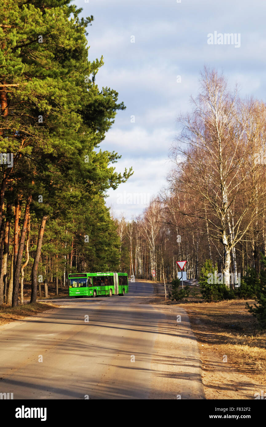 Spring sunny asphalt road with bus Stock Photo - Alamy
