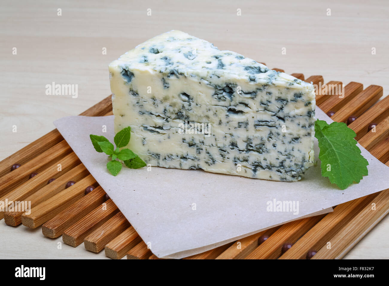 Dor Blue cheese with basil on the wood background Stock Photo - Alamy