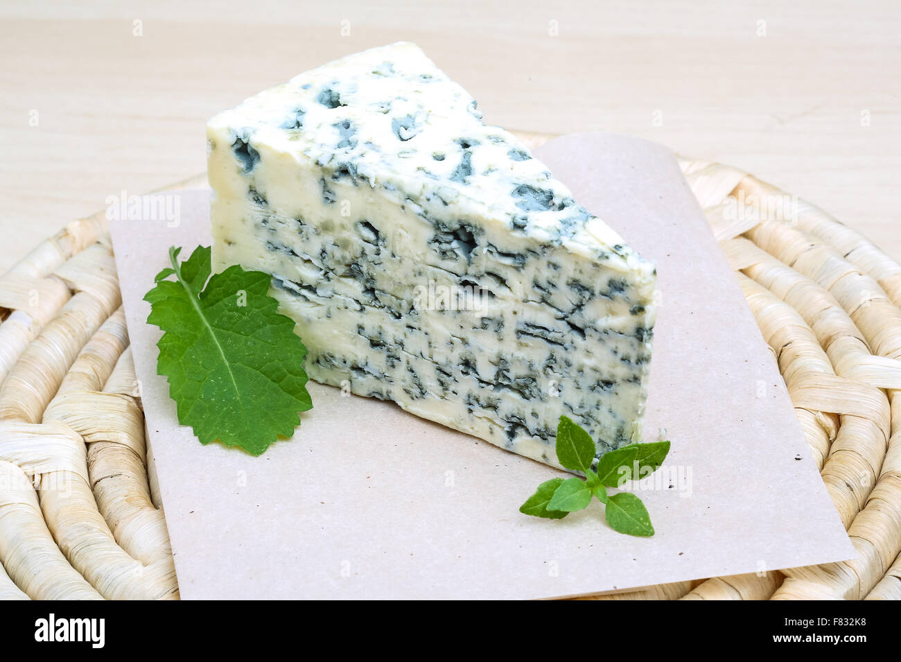 Dor Blue cheese with basil on the wood background Stock Photo - Alamy