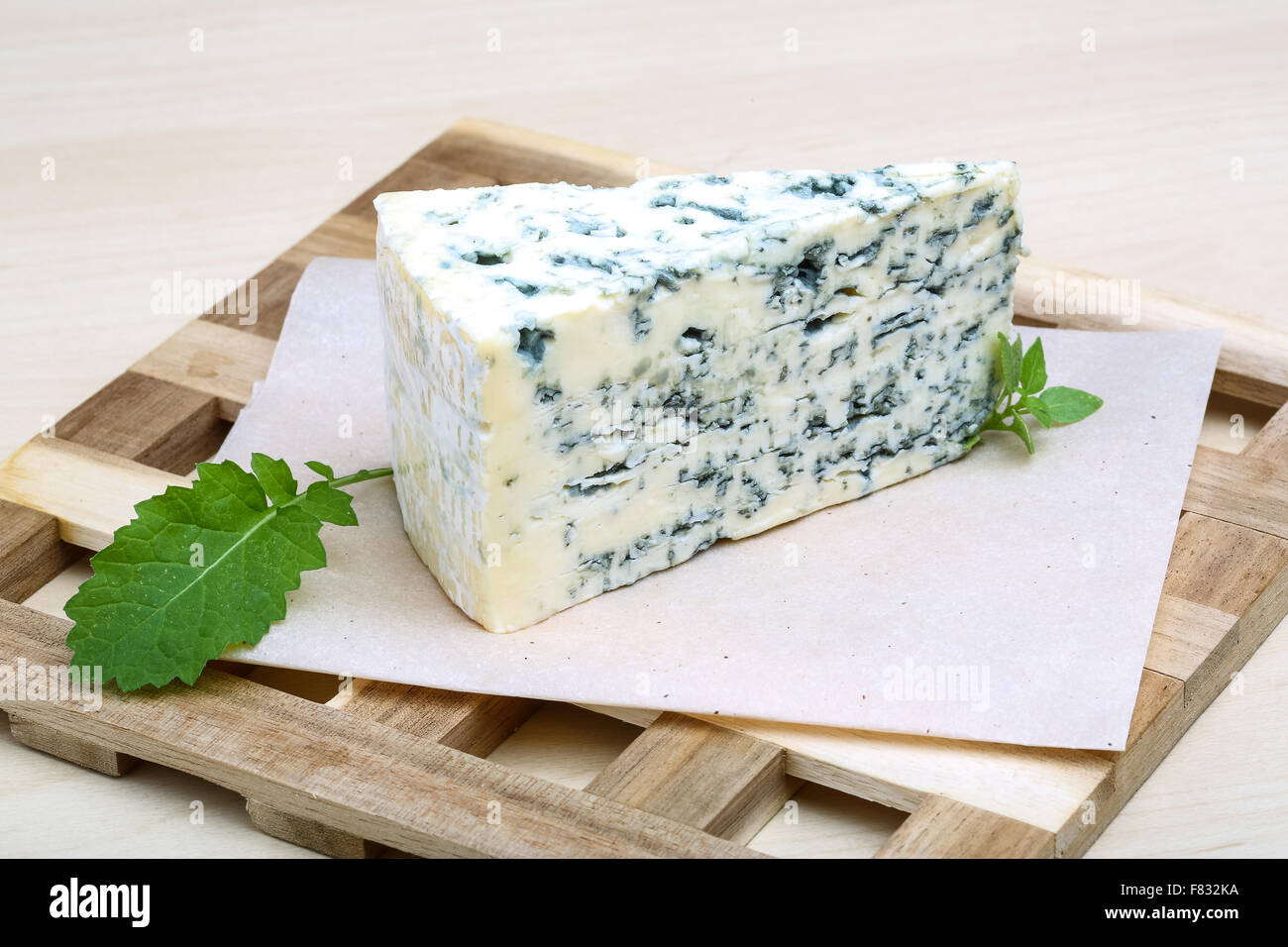 Dor Blue cheese with basil on the wood background Stock Photo - Alamy