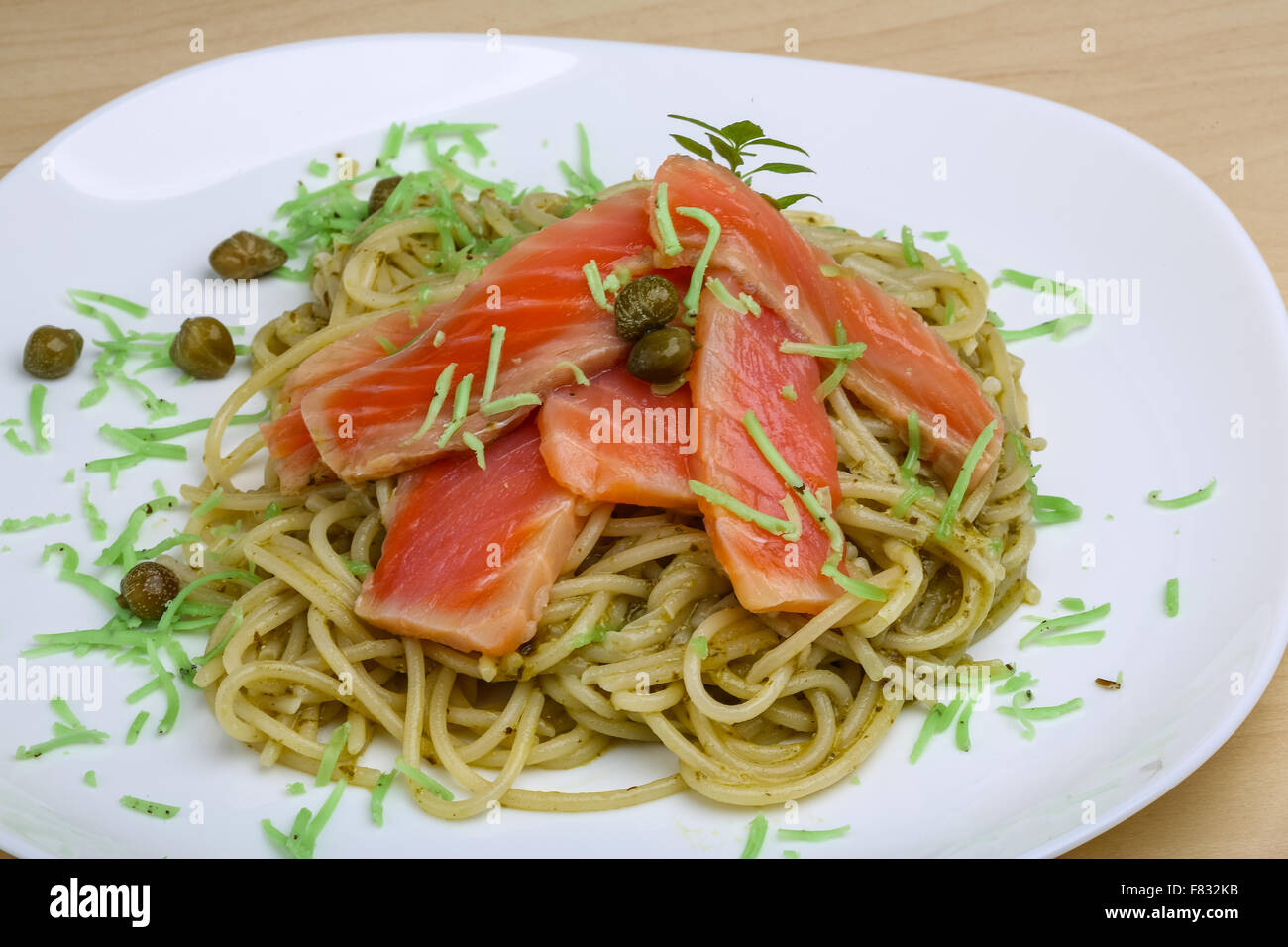 Pasta with salmon, green pesto cheese and capers Stock Photo - Alamy