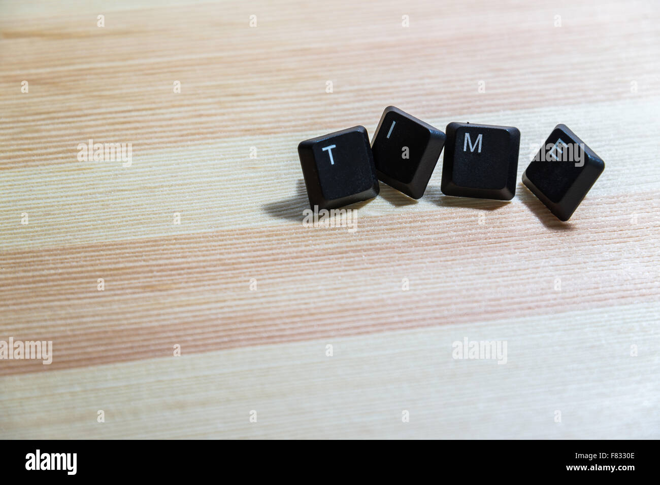 Time word keyboard on wooden floor Stock Photo - Alamy