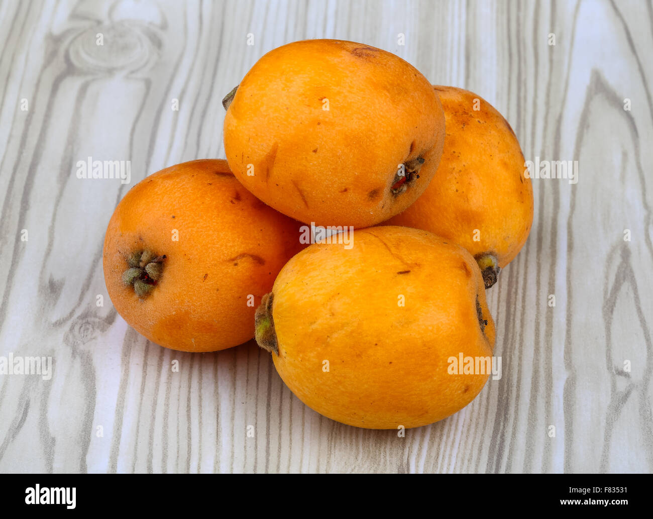 Fresh ripe sweet Medlar on the wood background Stock Photo - Alamy