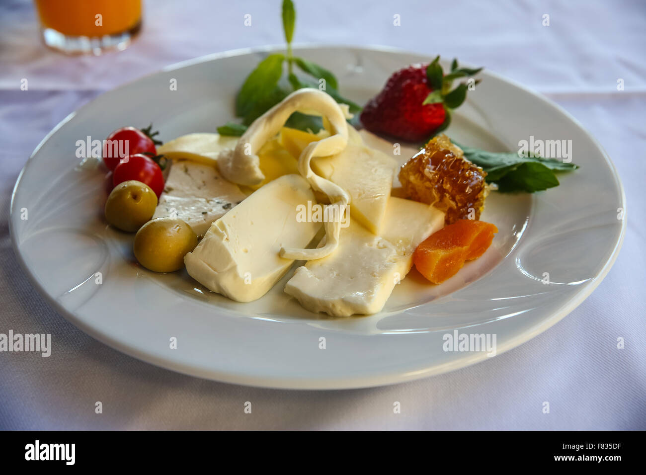 Cheese plate for breakfast with strawberry, honey and olive Stock Photo ...
