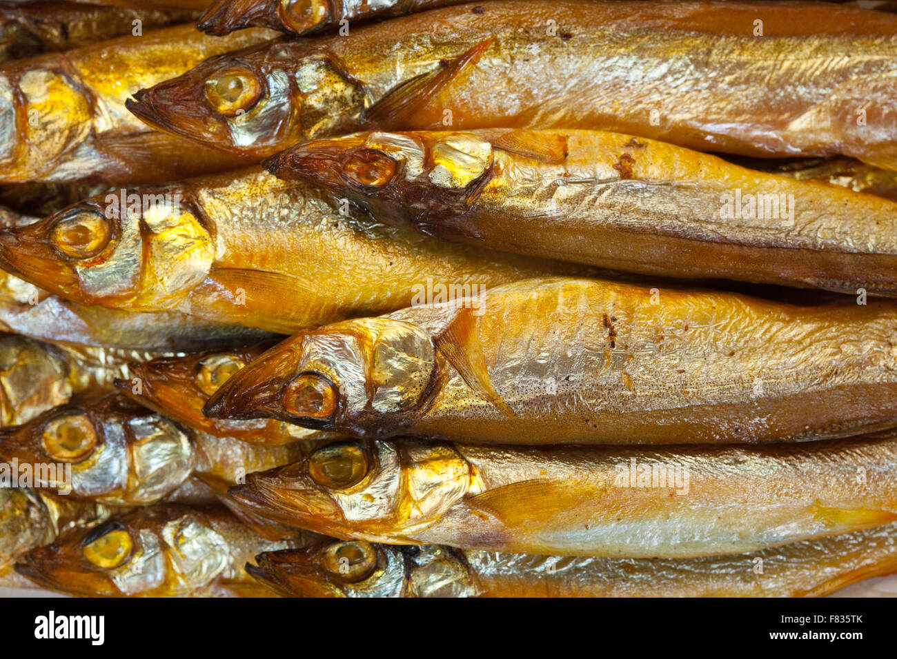 background of golden smoke-dried fish close up Stock Photo - Alamy