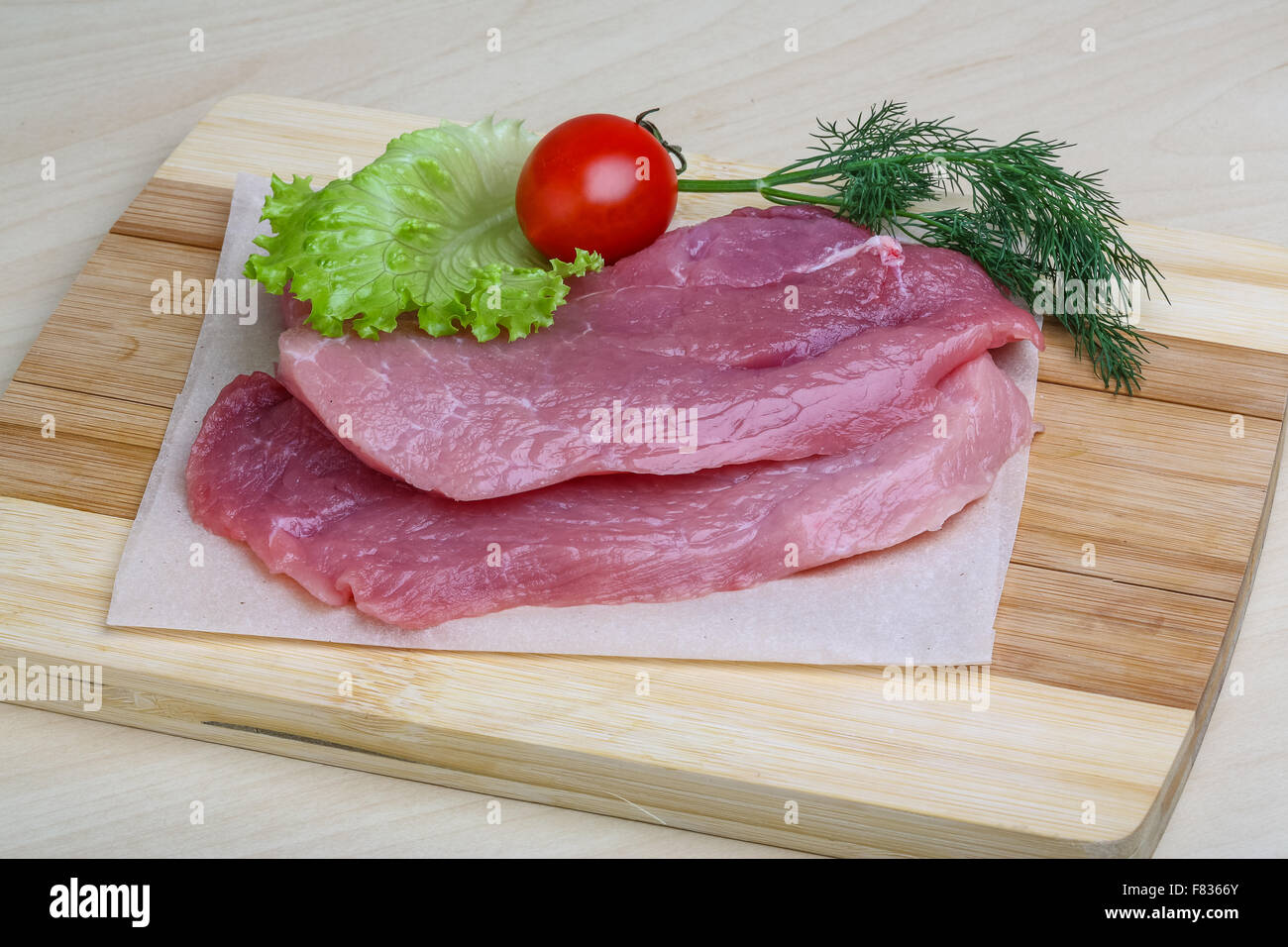 Raw pork schnitzel with dill - ready for cooking Stock Photo - Alamy
