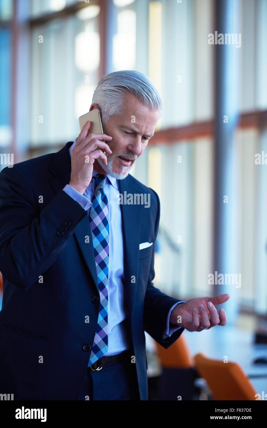 senior business man talk on mobile phone at modern bright office ...