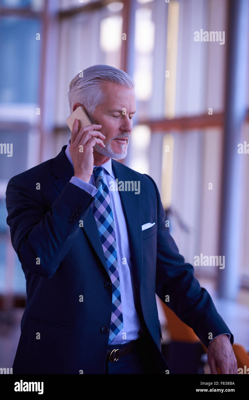 senior business man talk on mobile phone at modern bright office ...