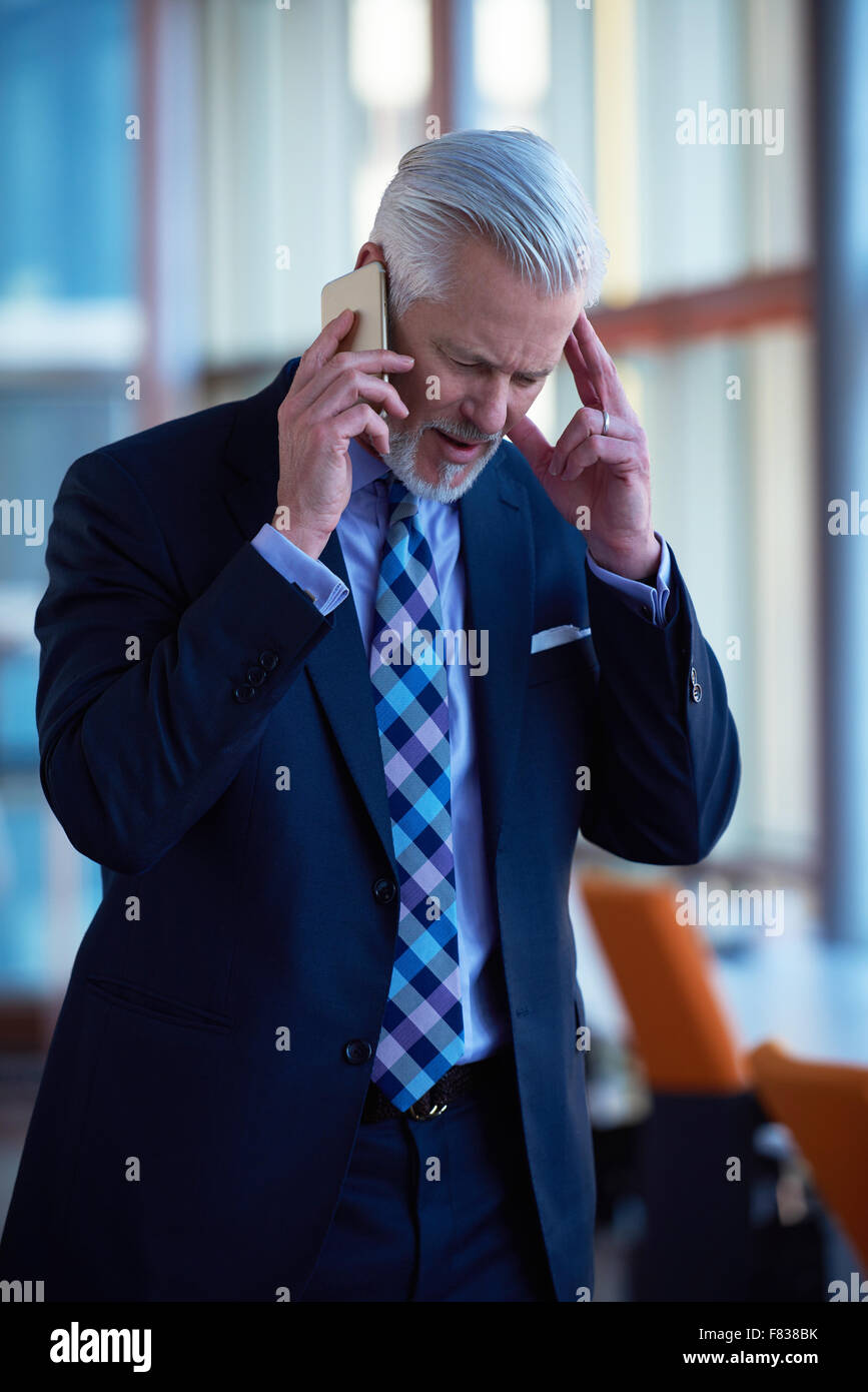 senior business man talk on mobile phone at modern bright office ...