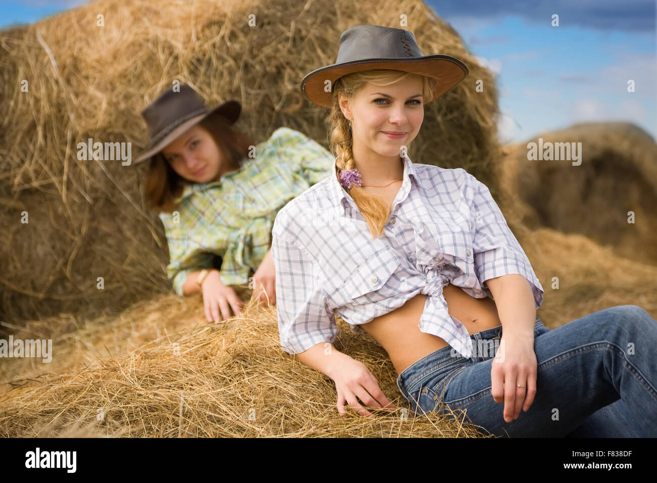 Farm girls on fresh hay at field Stock Photo - Alamy