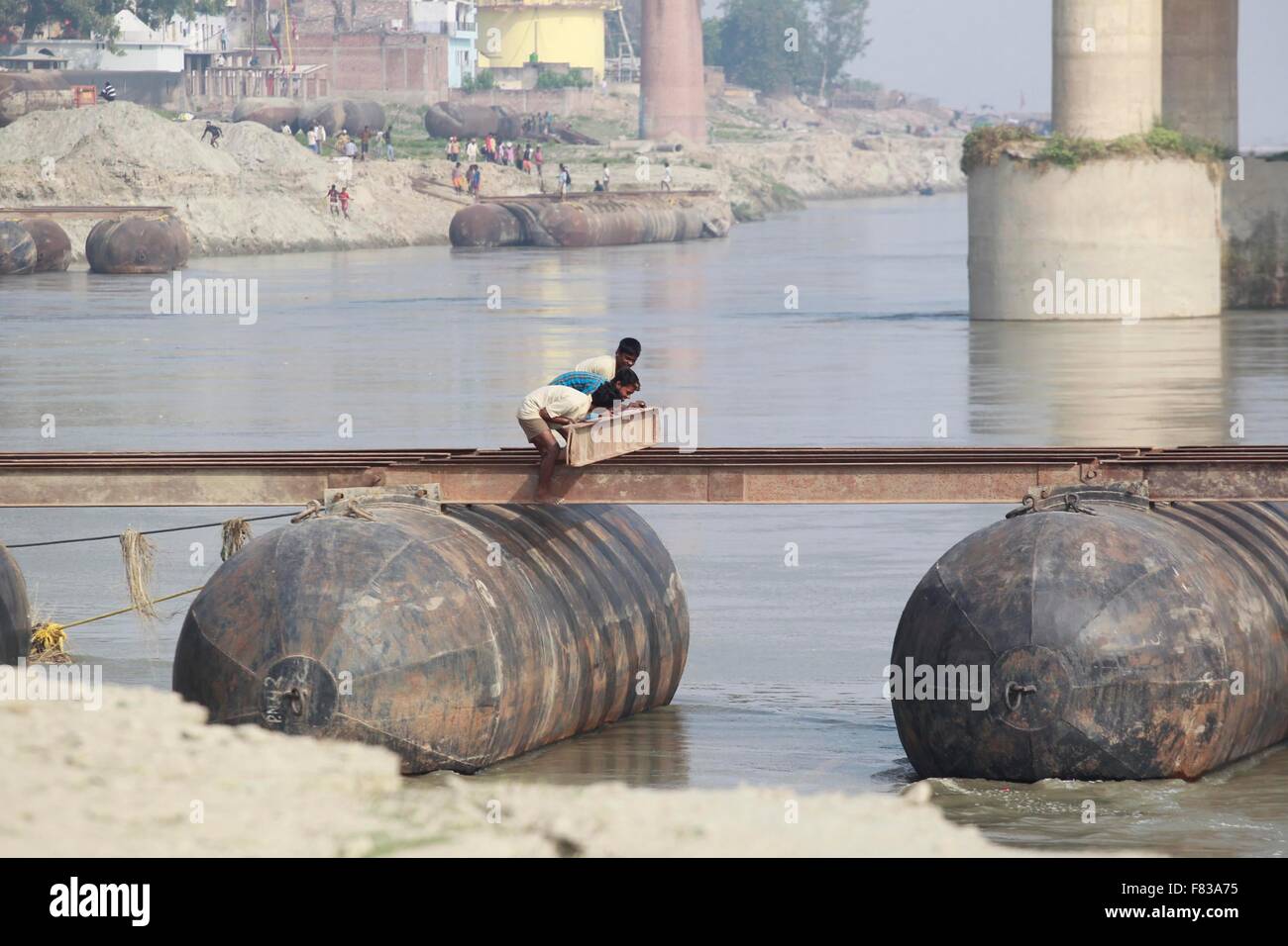 Laborers construct temporary pontoon bridge in the river Ganga ahead of ...