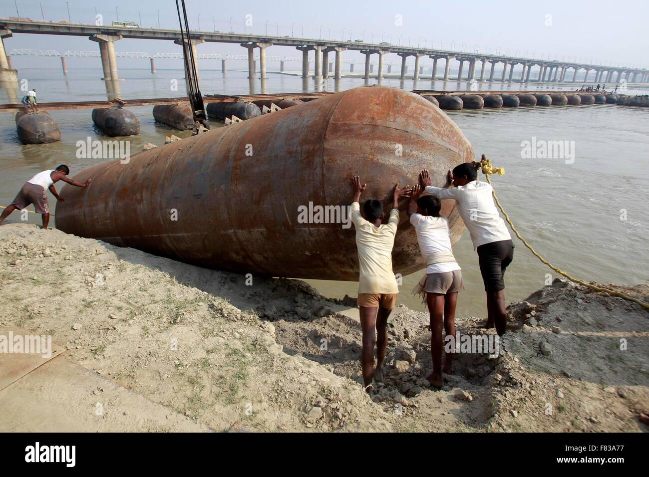 Laborers construct temporary pontoon bridge in the river Ganga ahead of ...