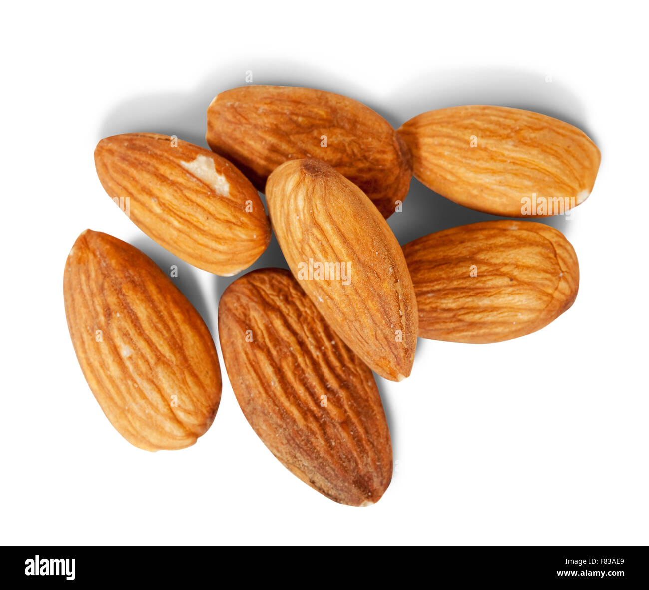 Few almond nuts. Isolated over white background Stock Photo - Alamy