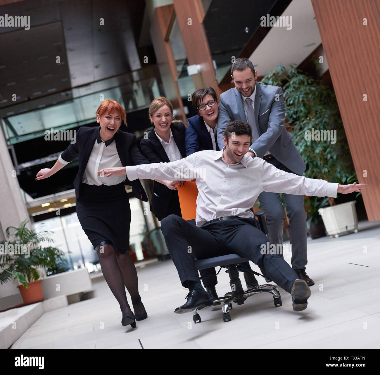 business people group at modern office indoors have fun and push office ...
