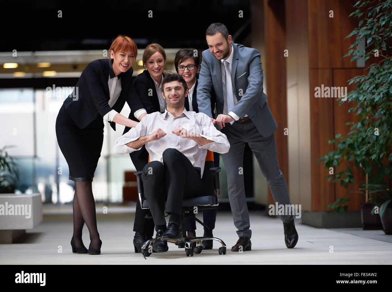 business people group at modern office indoors have fun and push office ...