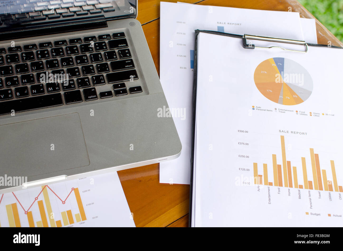 Modern business workplace with tablet, graphs and charts on a desktop ...