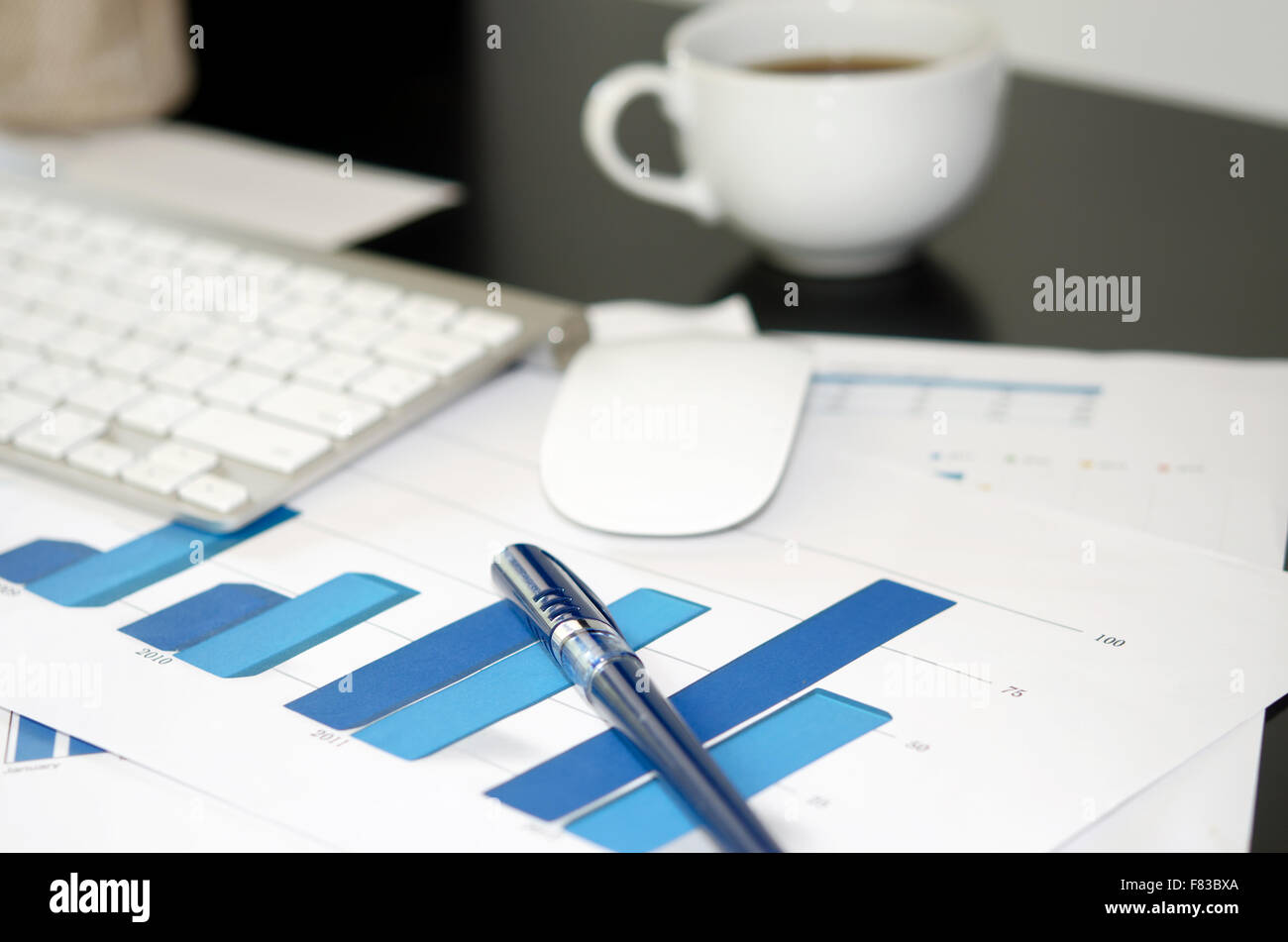 Financial graphs analysis and pen Stock Photo - Alamy