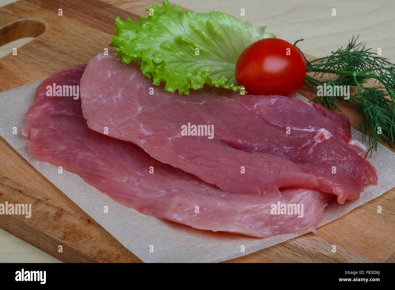 Raw pork schnitzel with dill - ready for cooking Stock Photo - Alamy