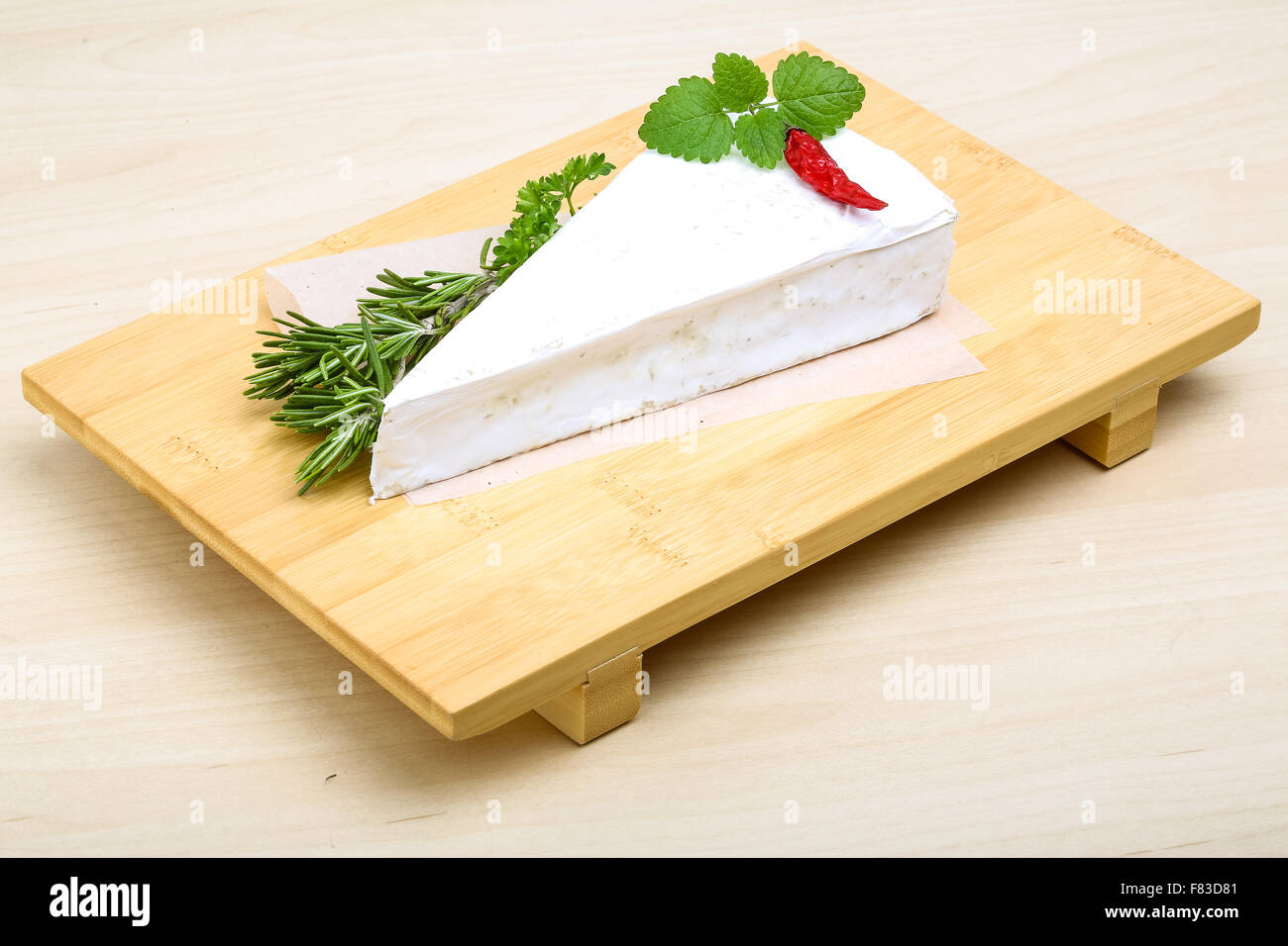 Soft brie cheese with rosemary, thyme on the wood background Stock ...